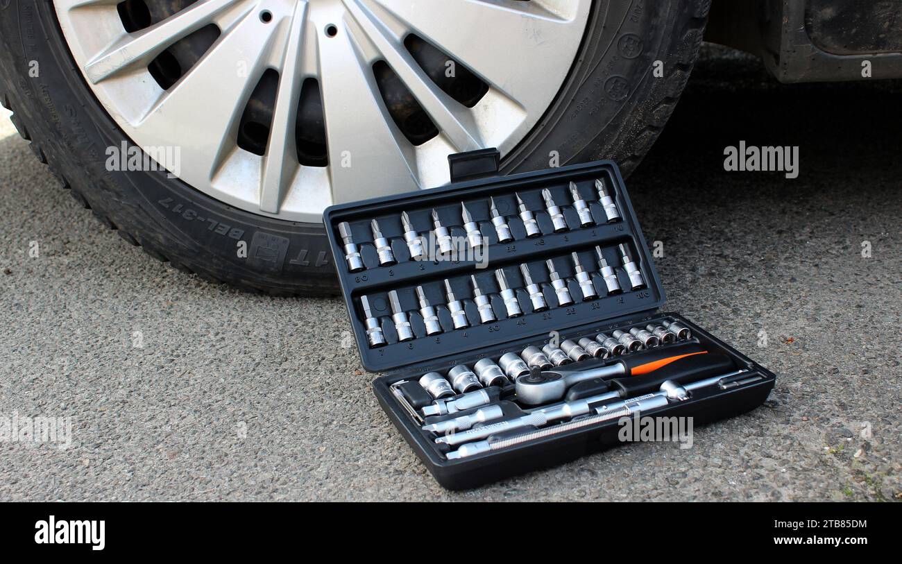 Mechanics Tools In Plastic Case With Open Lid Near Front Wheel Of Car ...