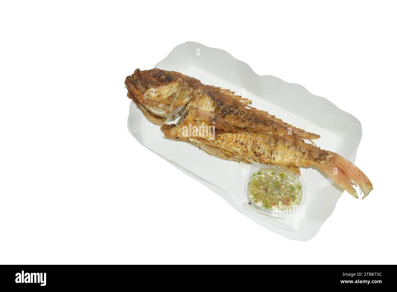 crispy fried fresh red snapper fish arranging on paper package dipping ...