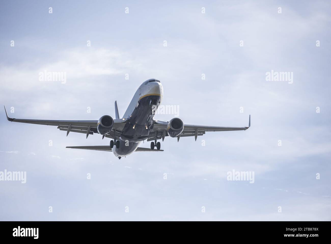 A multi-hued passenger plane approaching a runway Stock Photo - Alamy