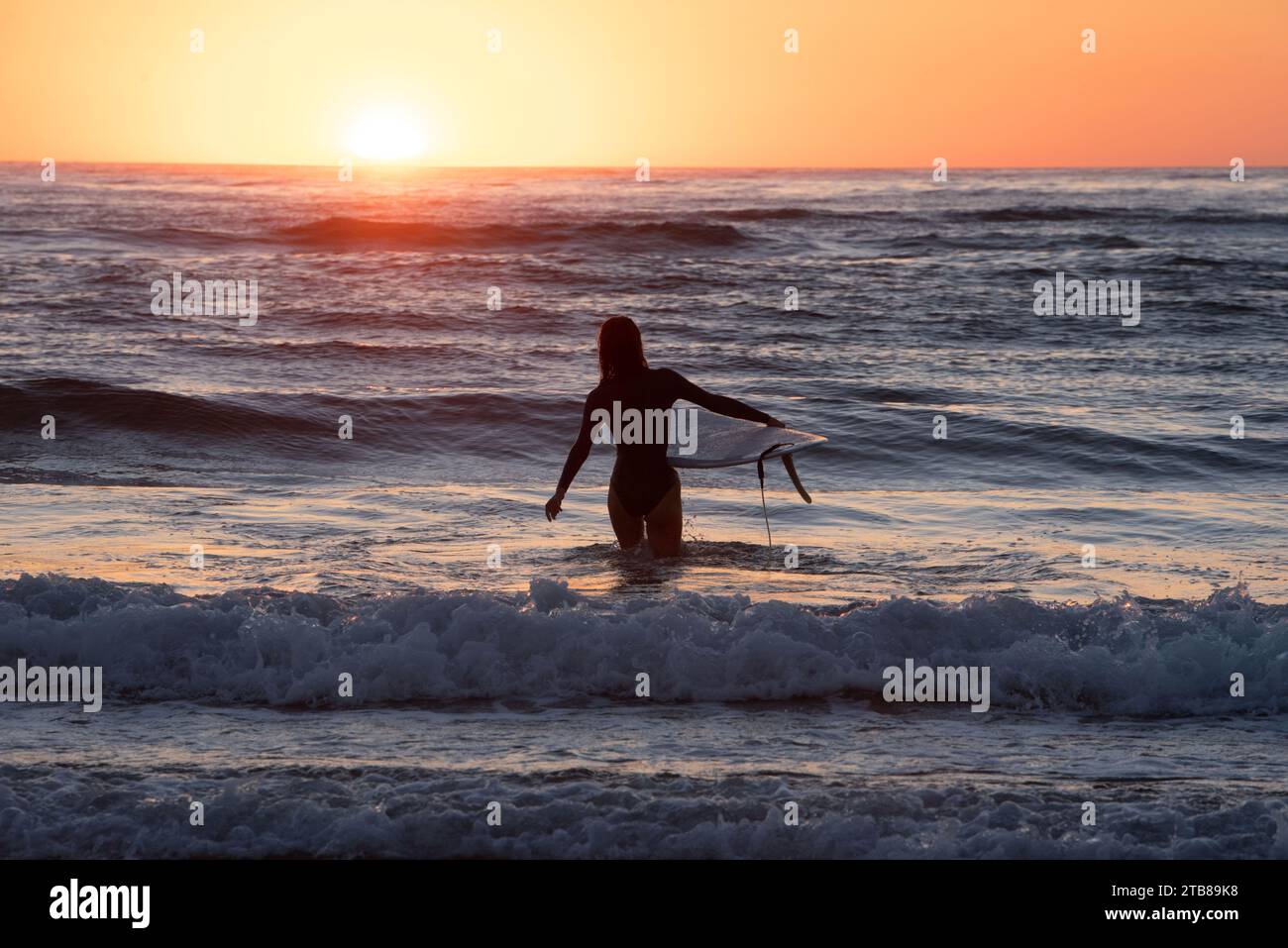 Vielle-Saint-Girons (south-western France): young woman, surfer, viewed ...