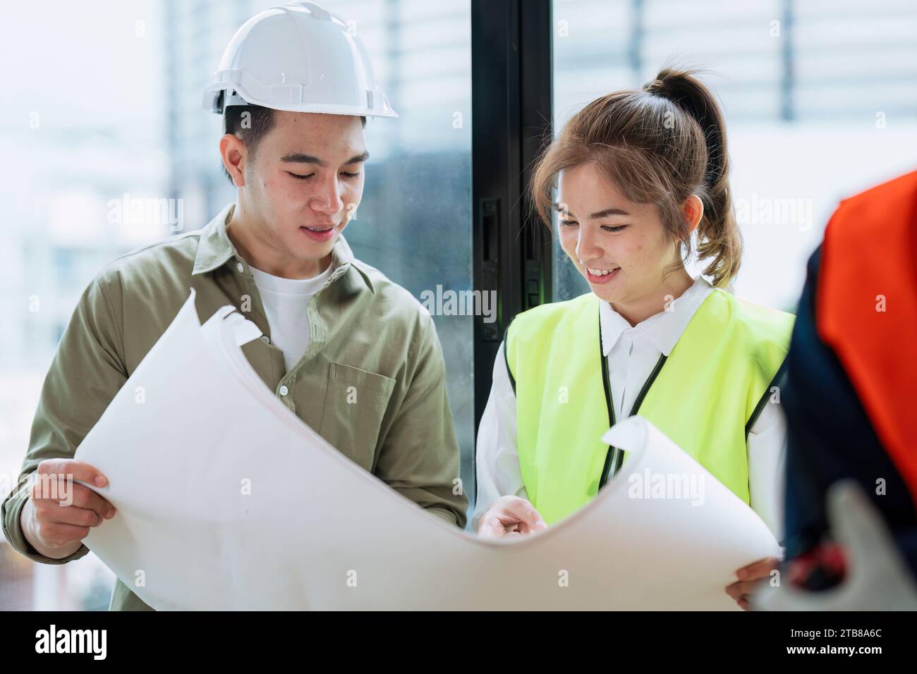 Civil engineers and architects inspecting and working building site ...