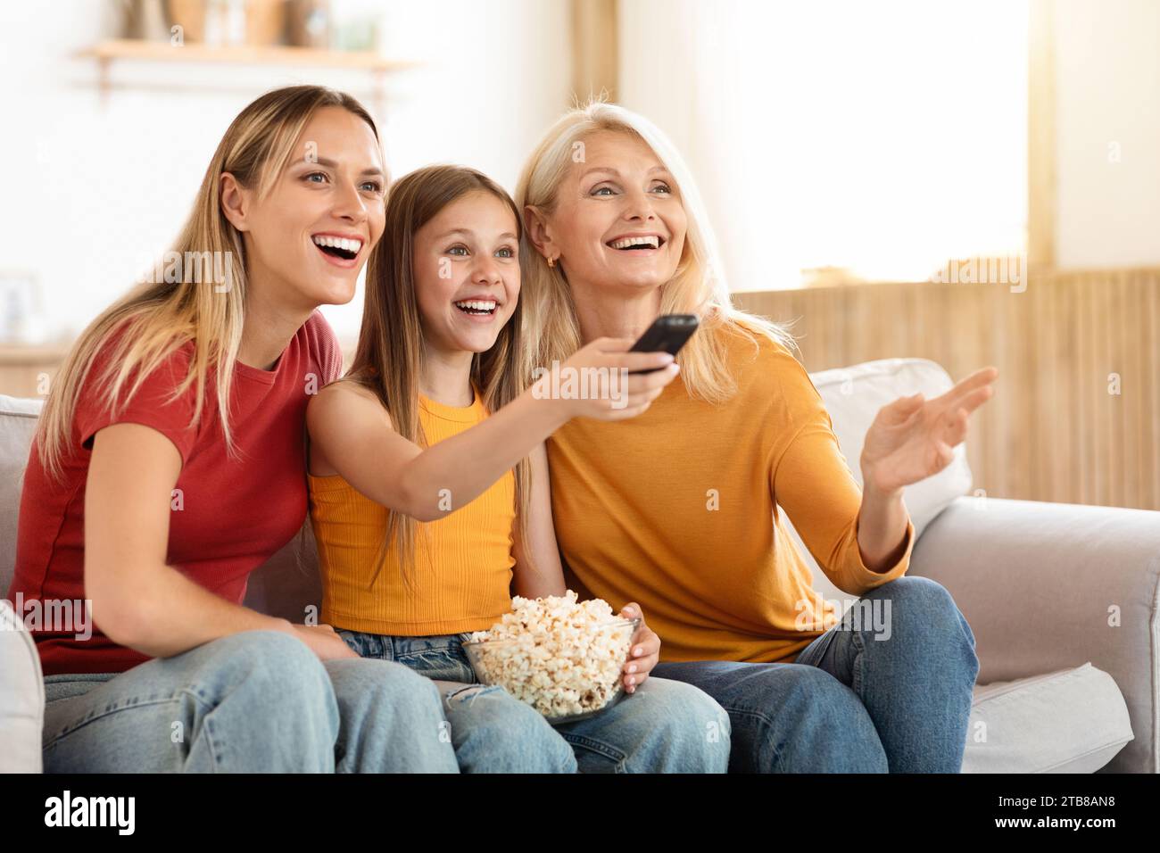 Three generations family watching tv hi-res stock photography and ...