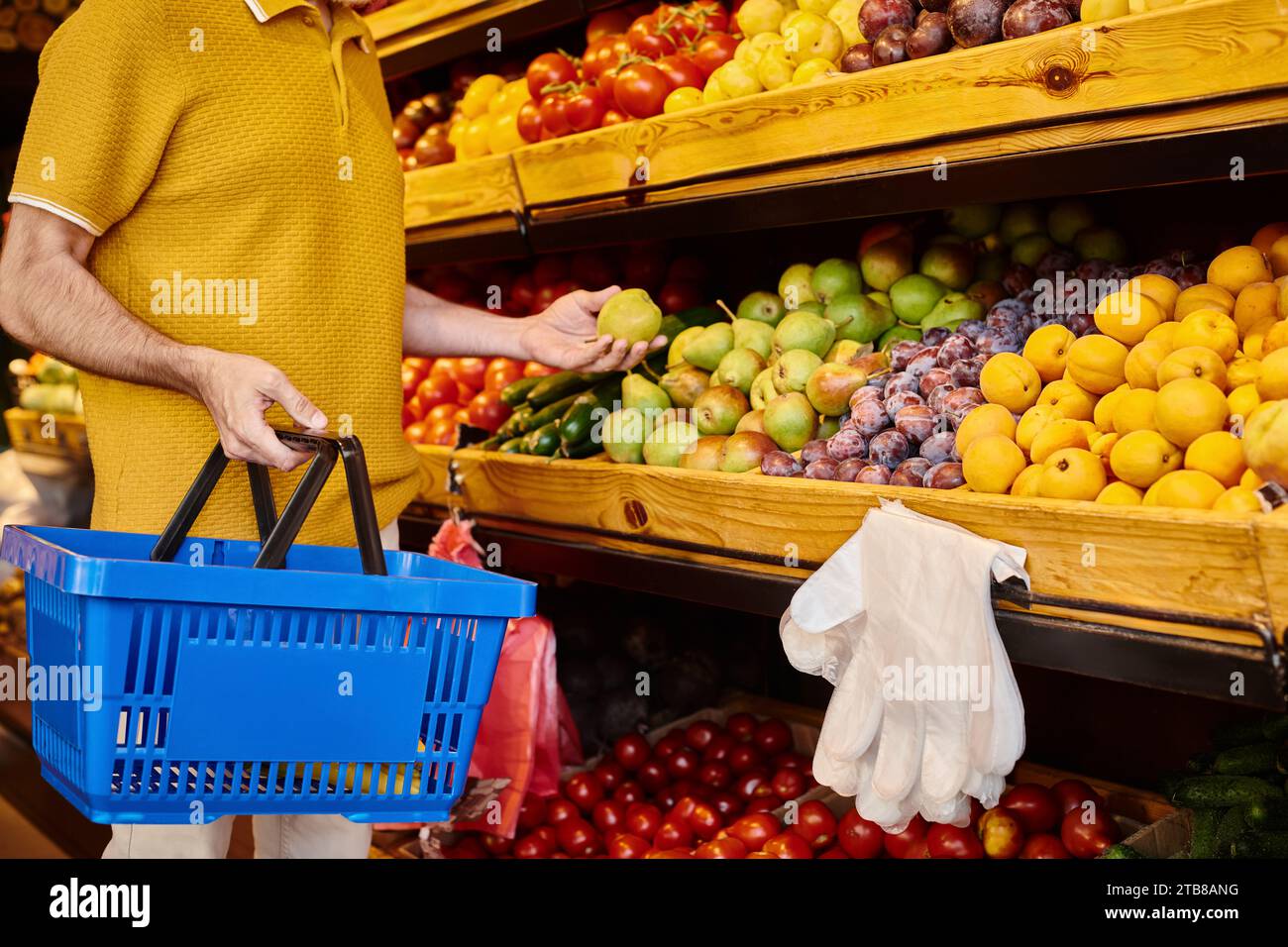 cropped view of mature male customer in casual attire picking fresh ...