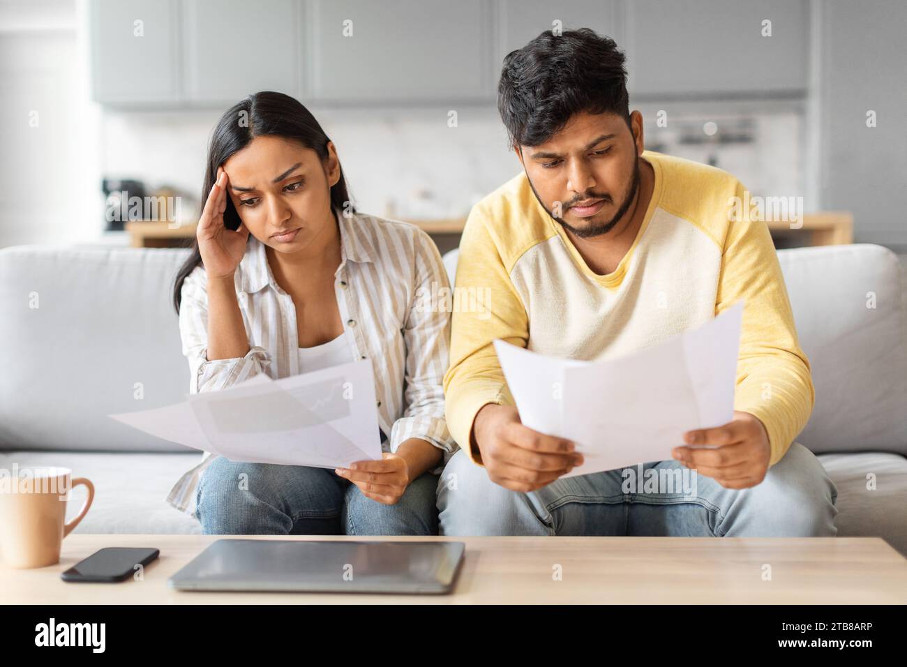 Stressed young indian spouses checking financial papers at home Stock ...