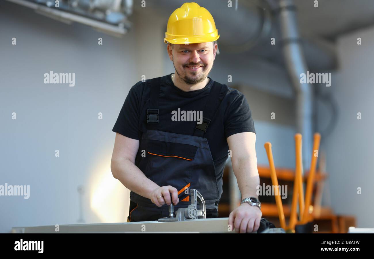 Worker using electric saw portrait Stock Photo - Alamy