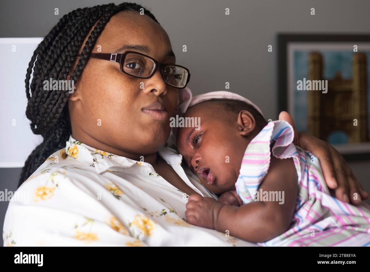 Asian Davis, 33, of Sikeston, Mo., cradles her 8-month-old daughter ...