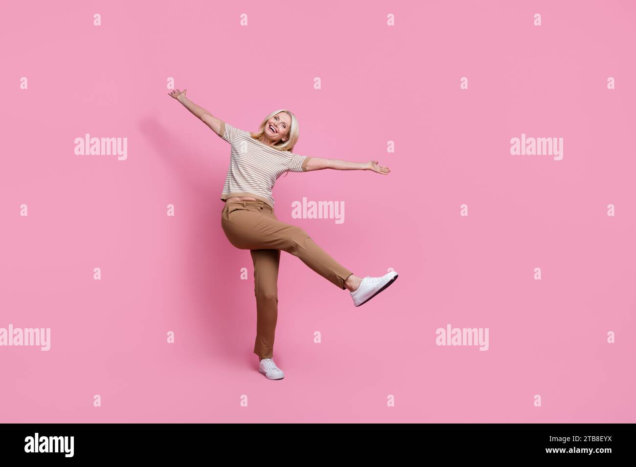 Full size photo of positive pretty person raise arms enjoy dancing ...