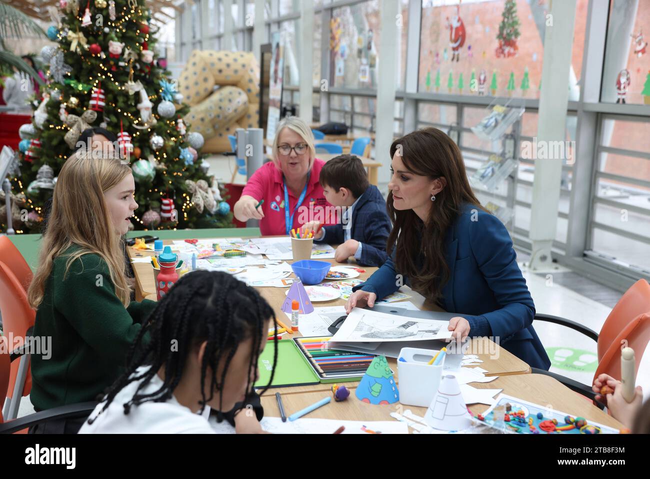 Britain's Kate, The Princess of Wales, right, speaks with children as ...