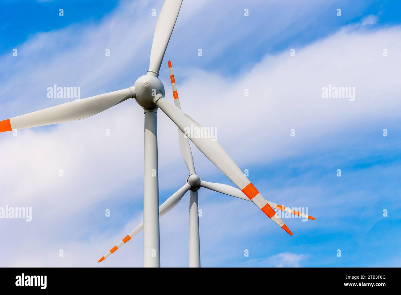 Wind turbine rotors against the blue sky. Green electricity production ...