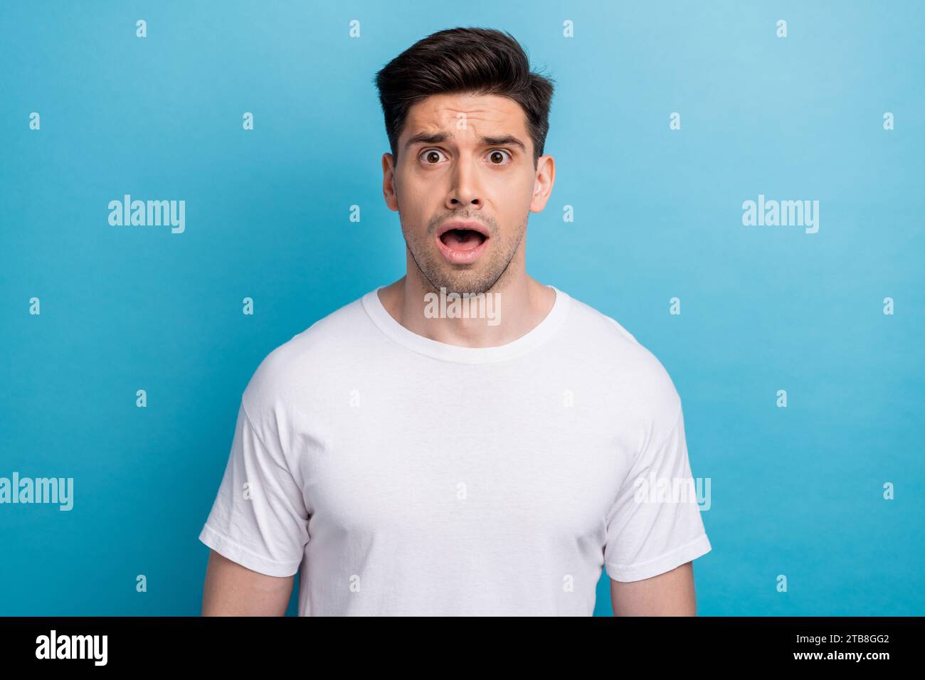 Photo of afraid scared guy wear white t-shirt big eyes open mouth ...
