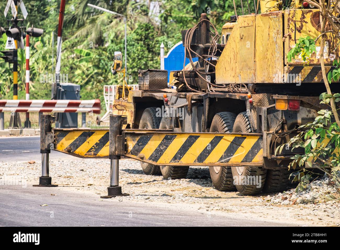 Large yellow machine truck with safety barrier protection repairing the ...