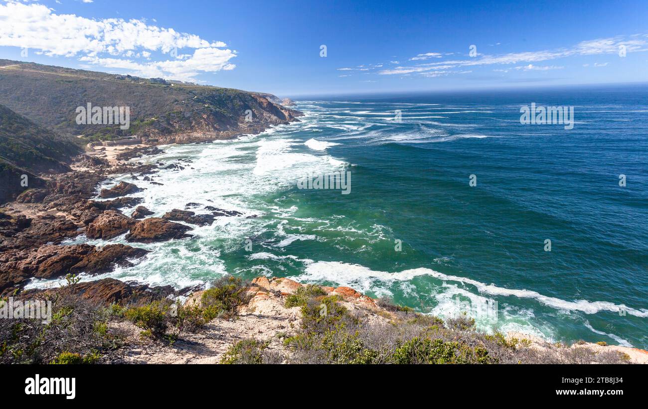 Rocky Cliffs Blue sky ocean waves distant horizon with white clouds a ...