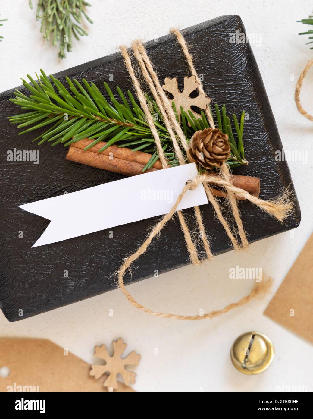 Black present with Christmas horizontal gift tag, fir tree branches ...