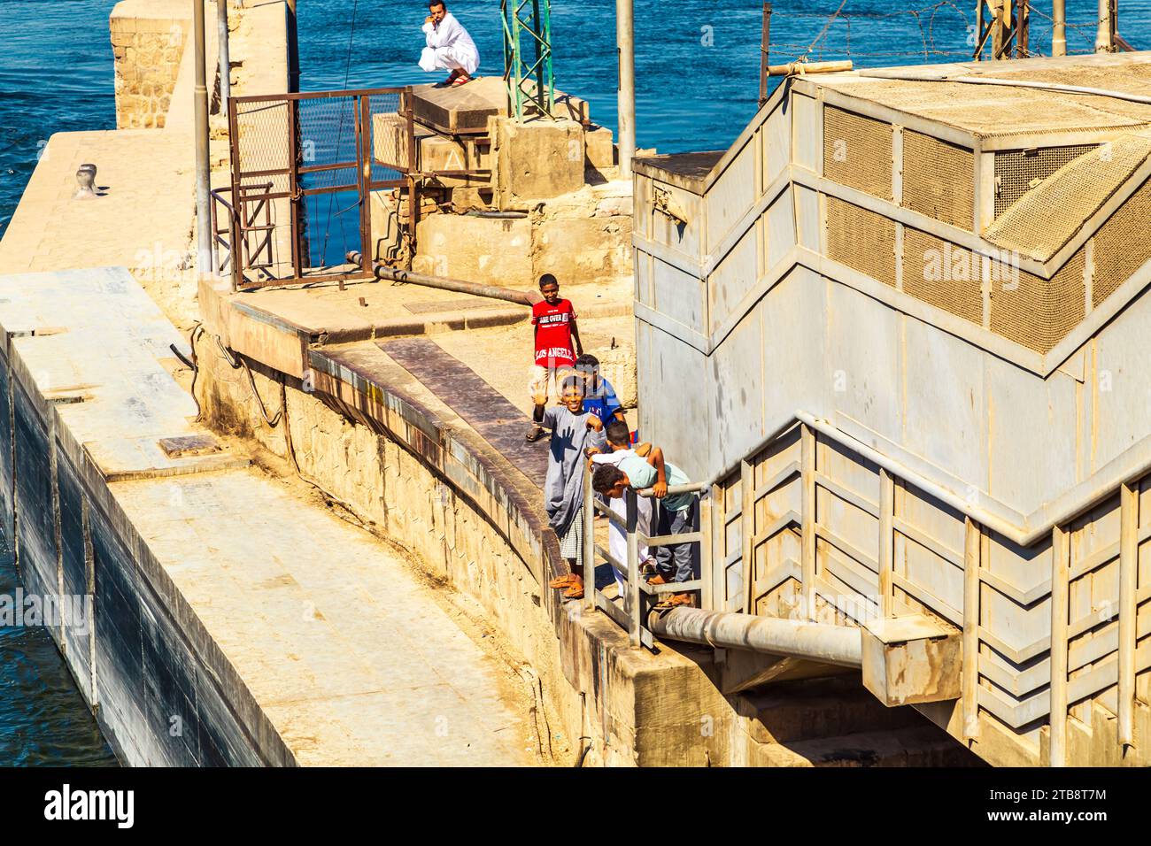 Egyptian children joyfully greet cruise ships passing through the Esna ...