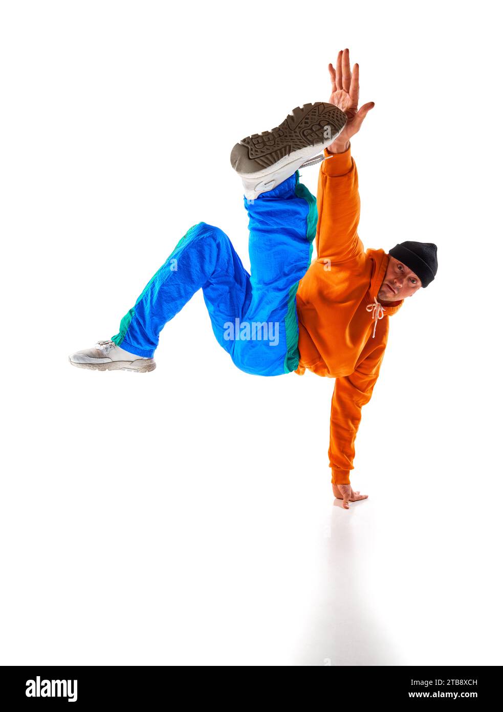 Stylishly dressed man, guy, professional dancer performing breakdance ...