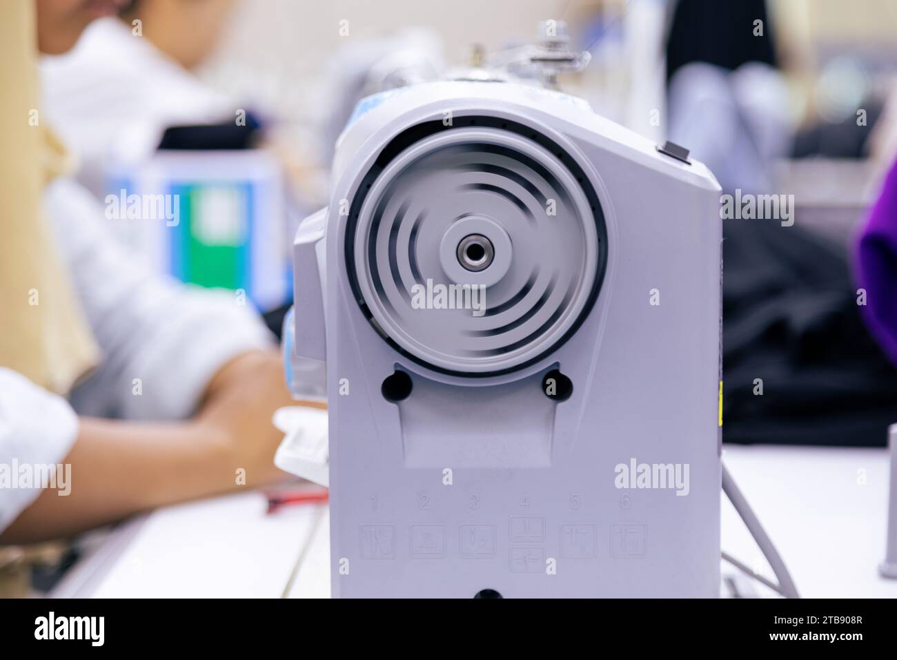 Close up of tailor working on electric sewing machine Stock Photo - Alamy