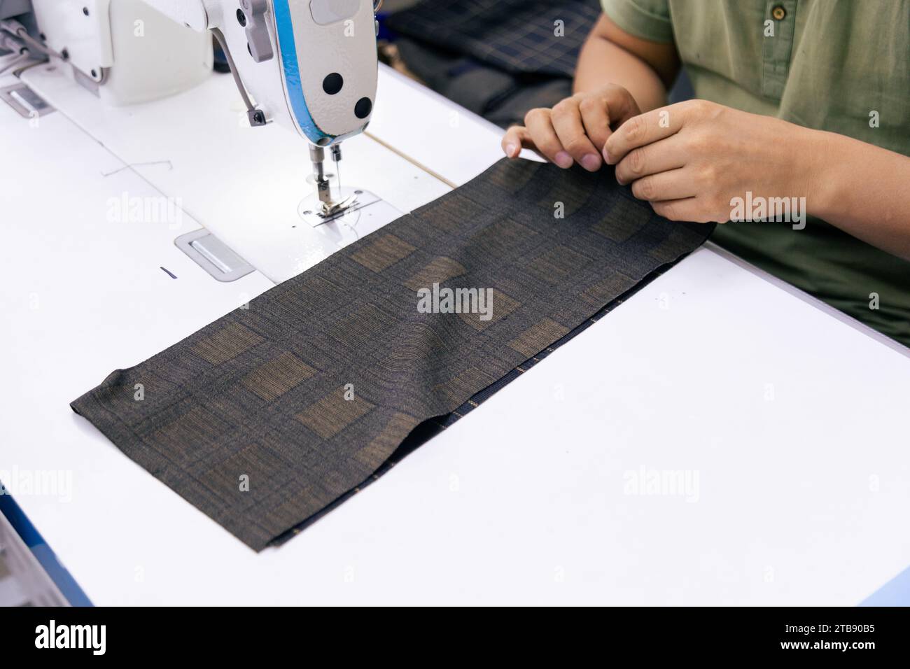 Close up of tailor working on electric sewing machine Stock Photo - Alamy
