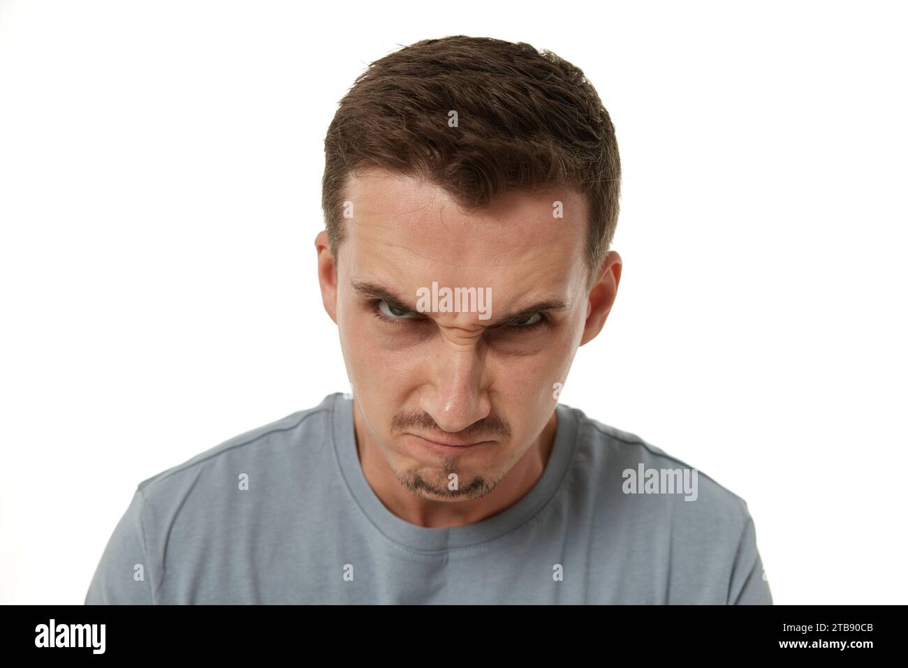 angry guy looking at camera on white studio background Stock Photo - Alamy