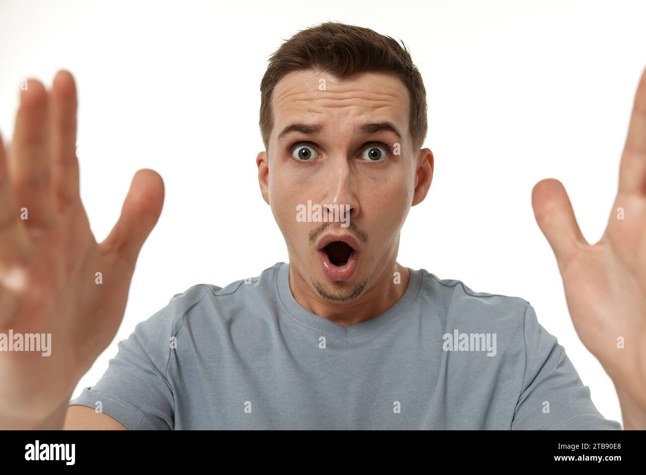 surprised guy looking at camera on white studio background Stock Photo - Alamy