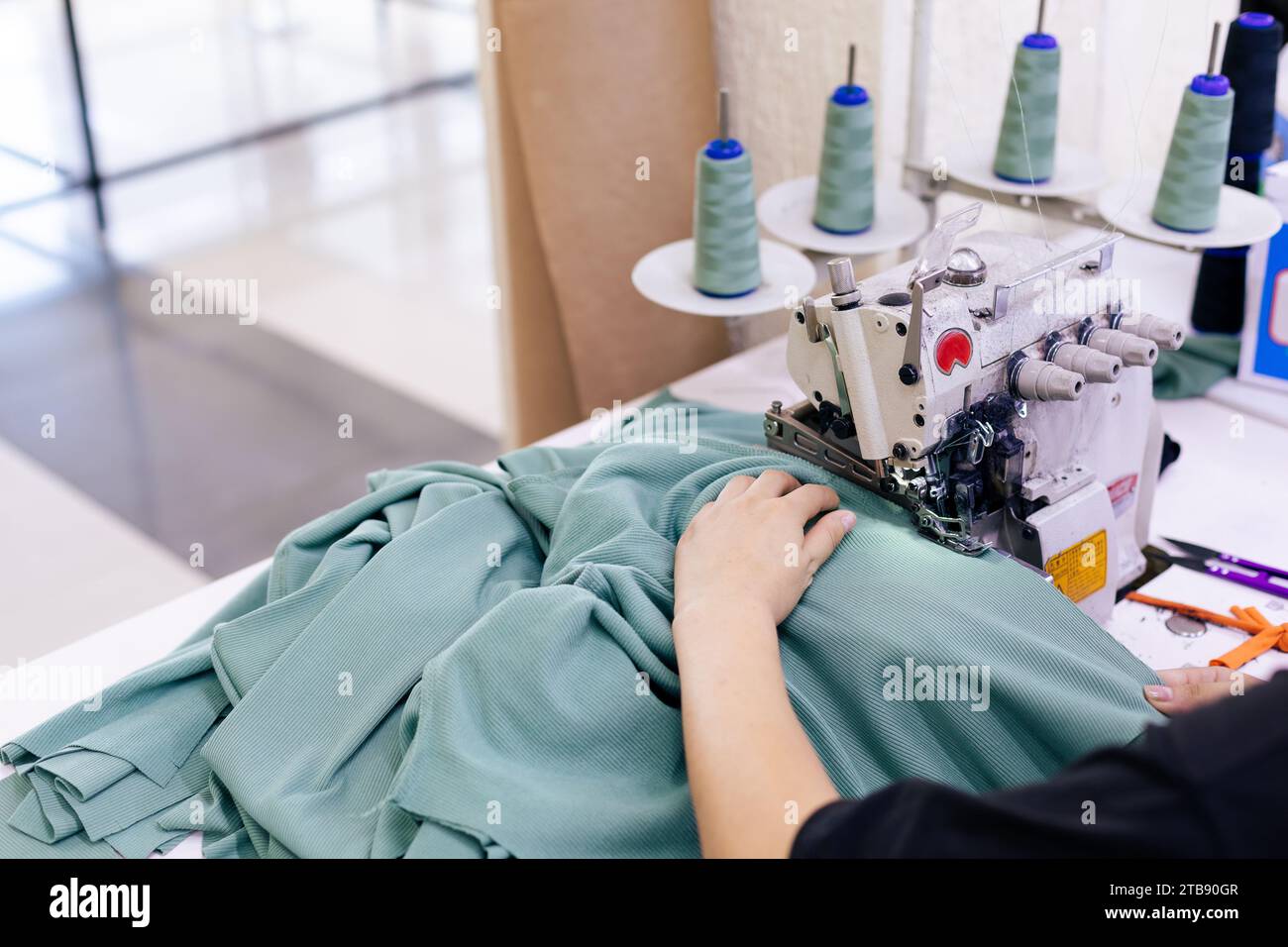Close up of tailor working on electric sewing machine Stock Photo - Alamy
