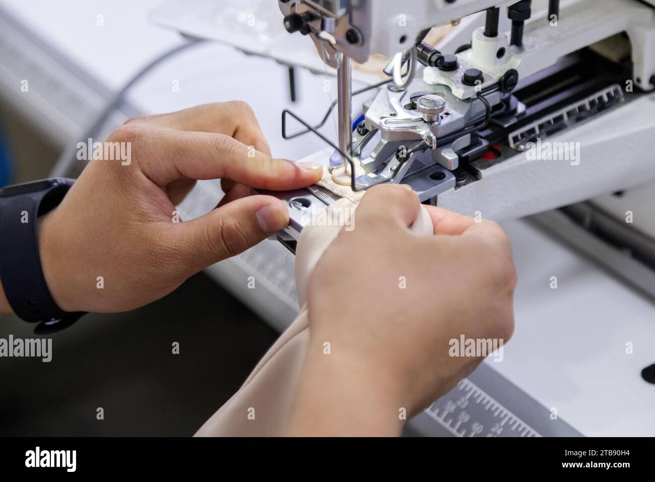 Close up of tailor sewing button on electric sewing machine Stock Photo ...