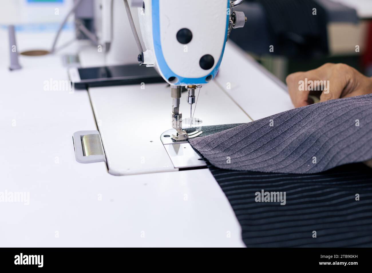 Close up of tailor working on electric sewing machine Stock Photo - Alamy