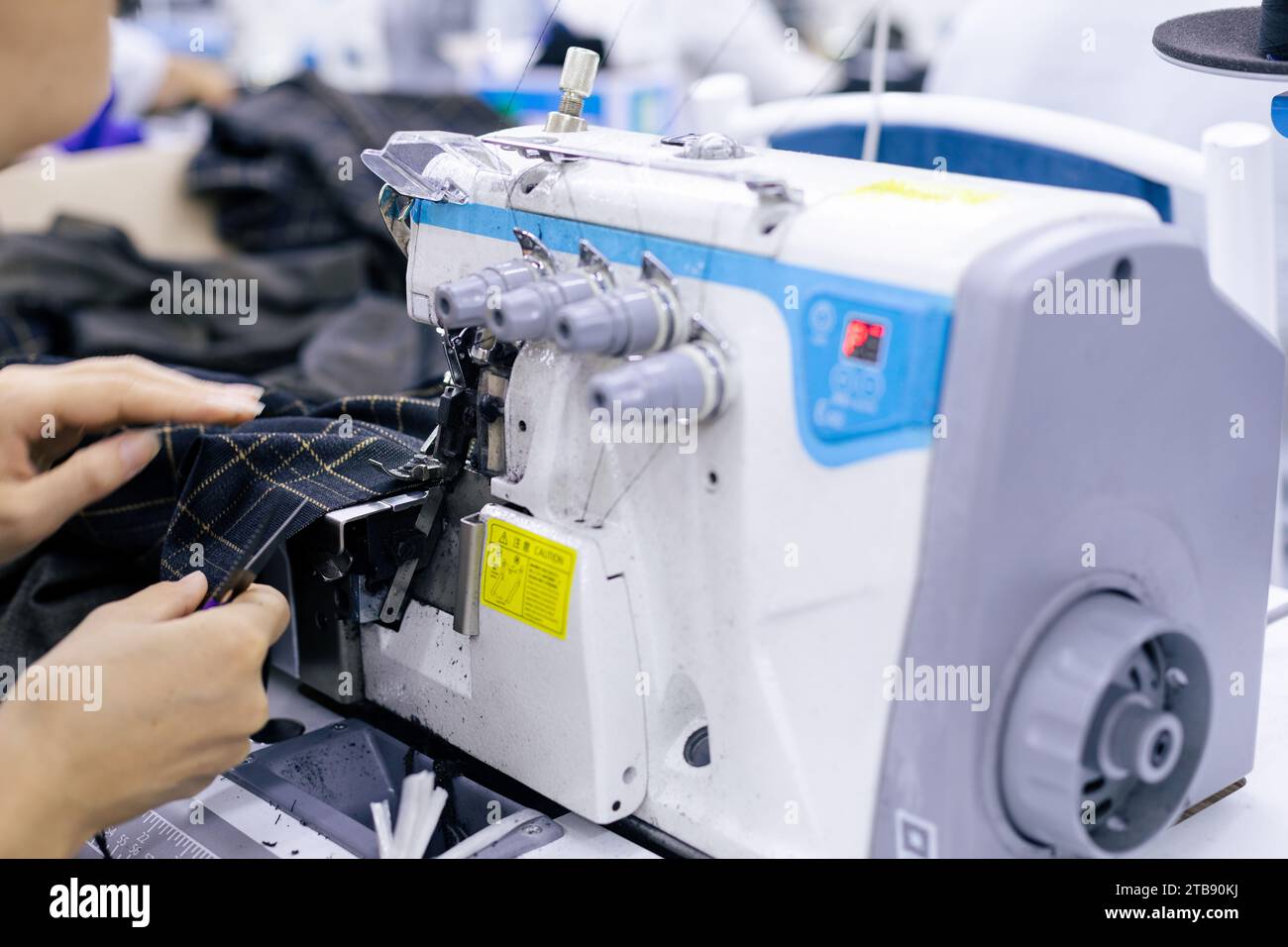 Close up of tailor working on electric sewing machine Stock Photo - Alamy