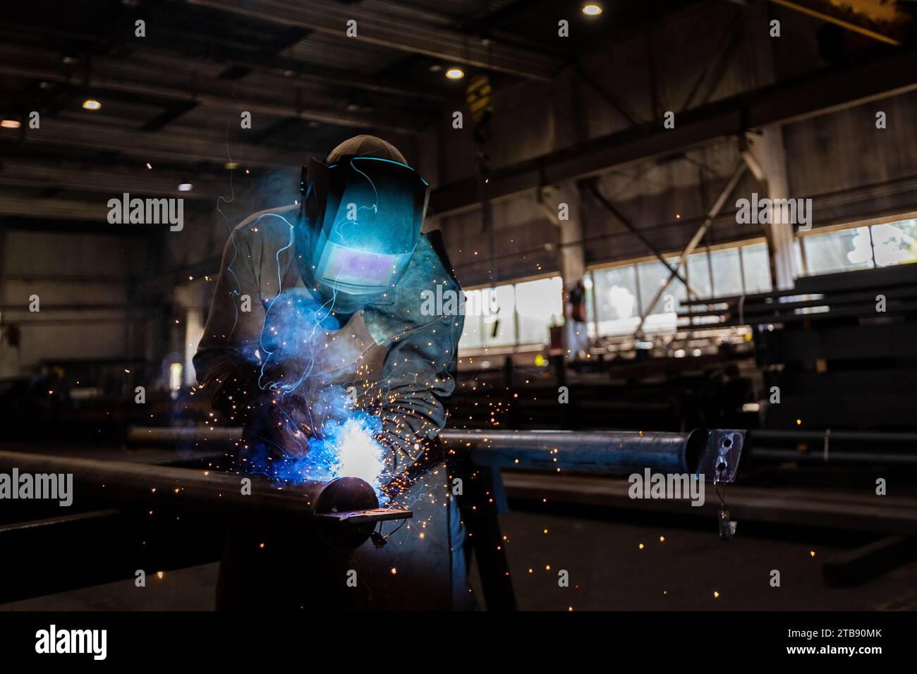 The welder works in the workshop. The moment of welding of metal ...