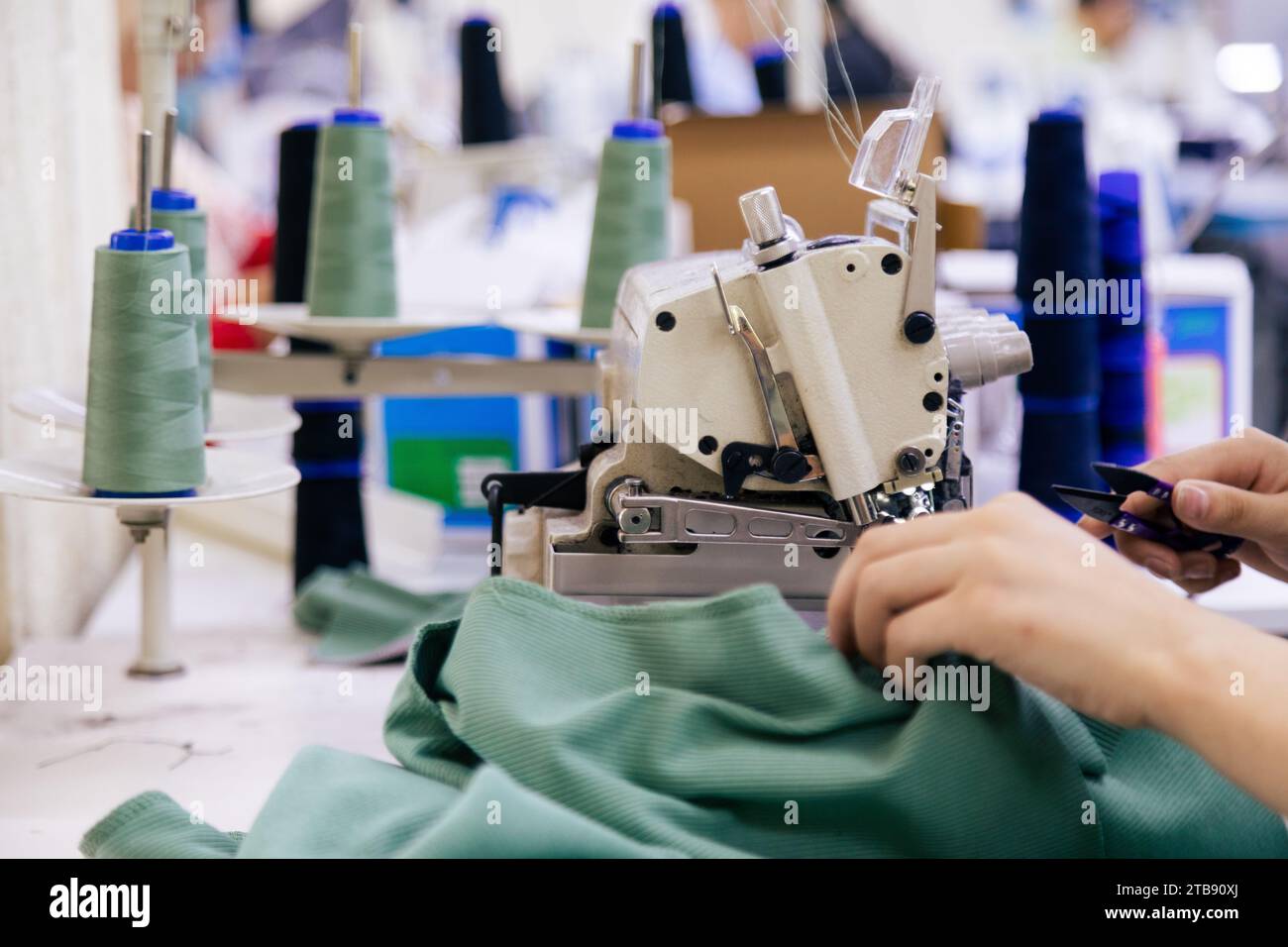Close up of tailor working on electric sewing machine Stock Photo - Alamy