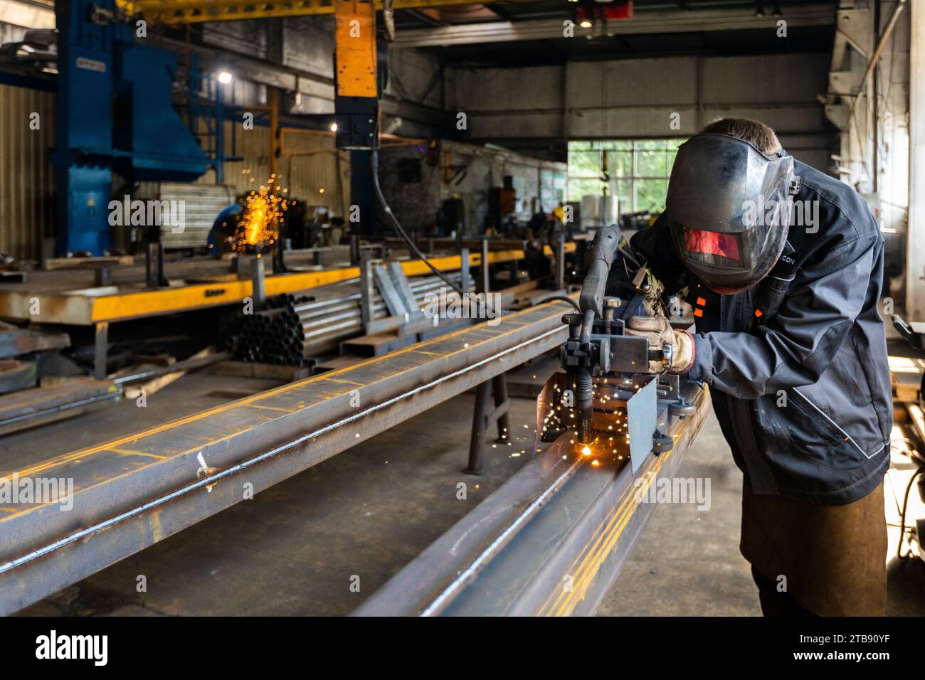 The welder works in the workshop. The moment of welding of metal ...