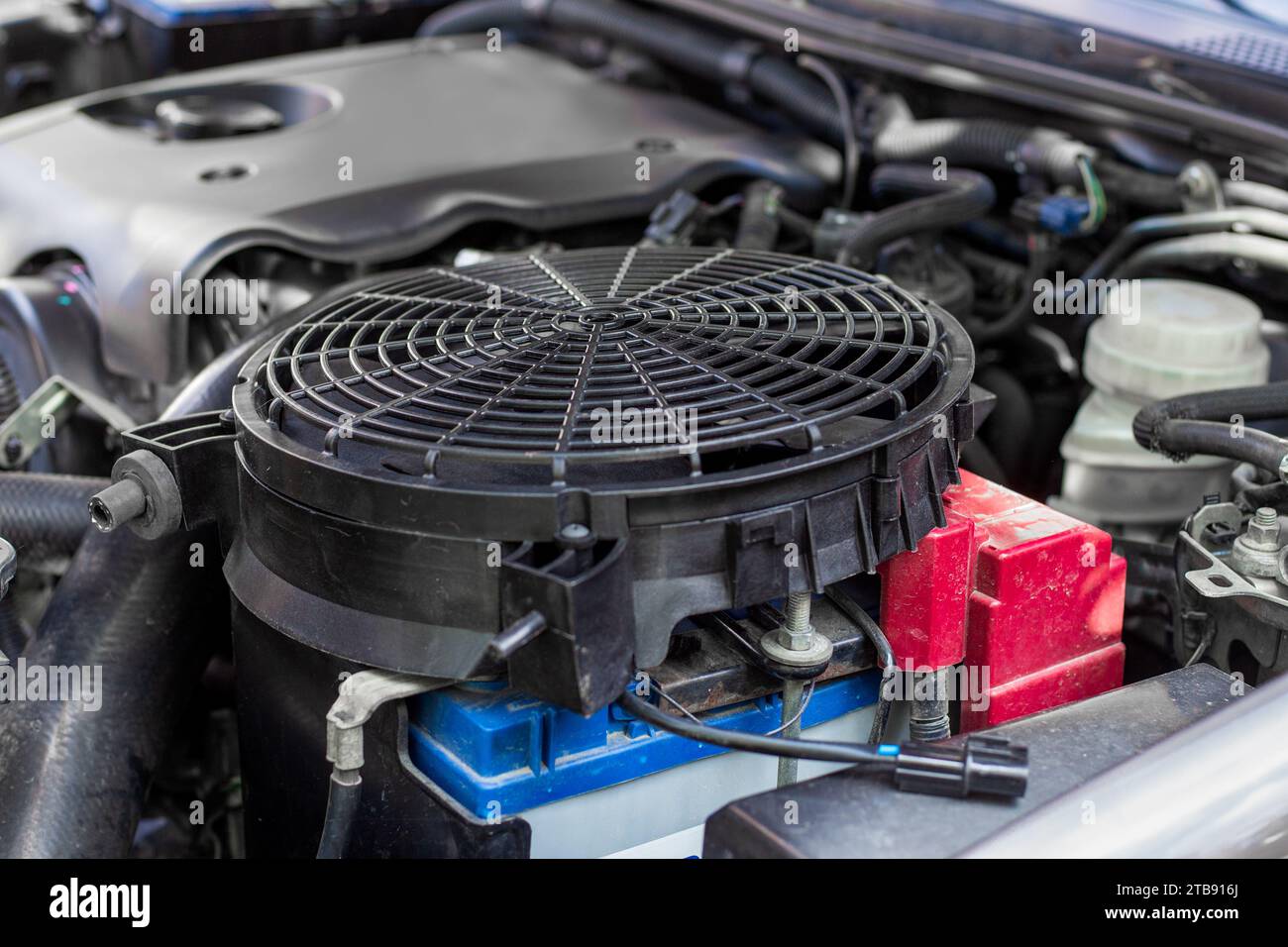 The engine cooling fan is prepared for installation under the hood of a ...