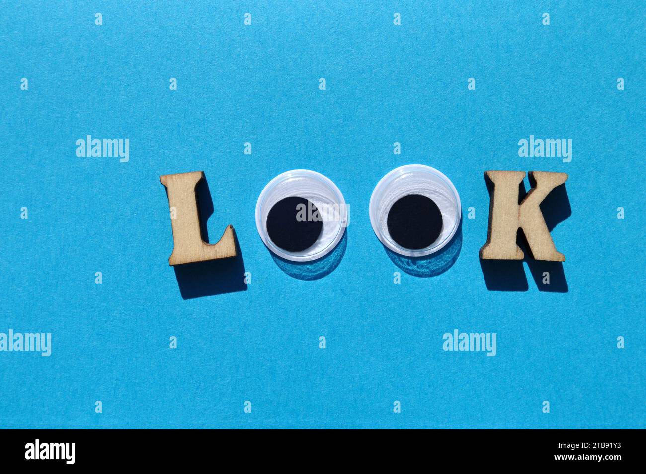 Look, word in wooden alphabet letters with fun googly eyes isolated on ...