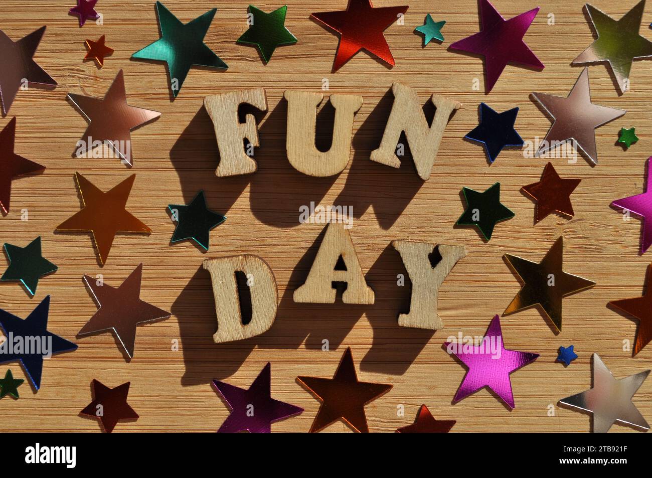 Fun Day, words in wooden alphabet letters surrounded by shiny colourful ...
