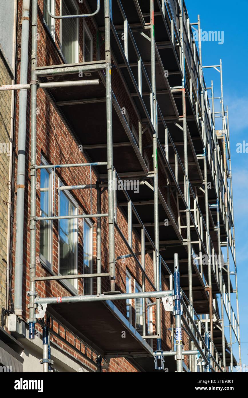 scaffolding work on the front of an old city building in Denmark ...