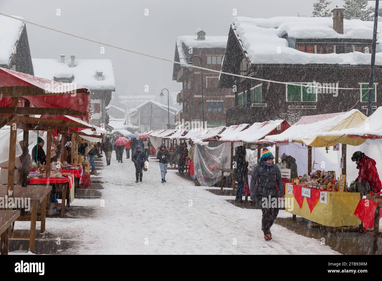 Cold wave and snow in Europe in an alpine mountain village. People are ...