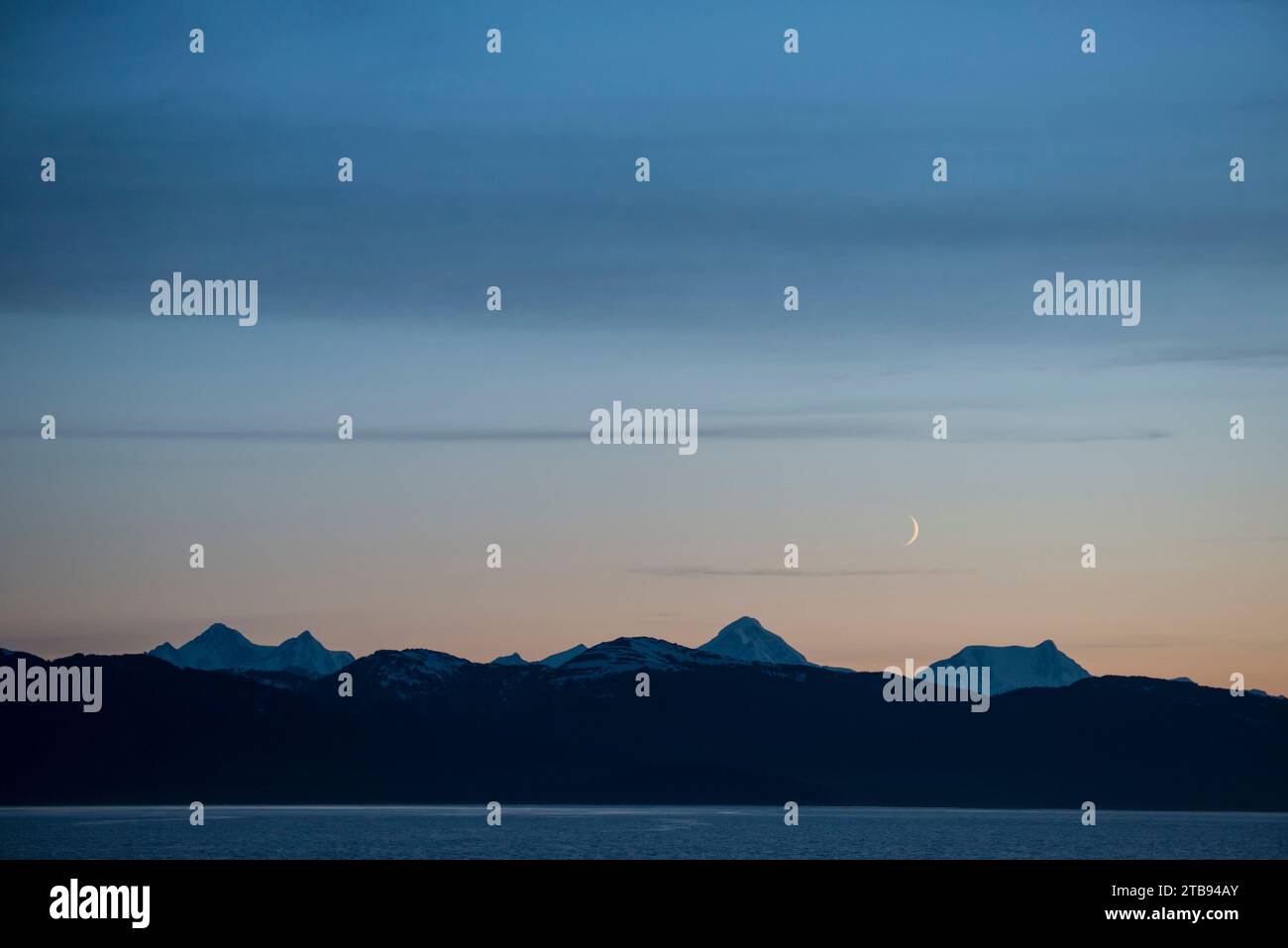 Crescent moon above Glacier Bay at dusk, Inside Passage, Alaska, USA ...