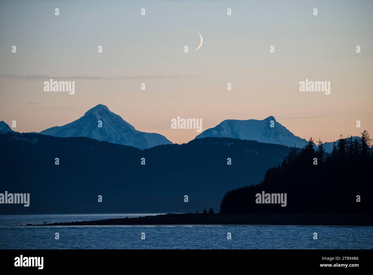 Crescent moon above Glacier Bay at dusk, Inside Passage, Alaska, USA ...