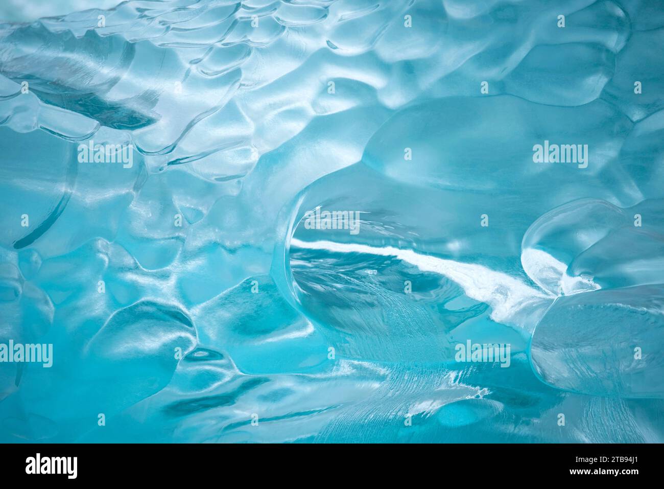 Close-up of a hole gouged into an iceberg at the waterline near the ...