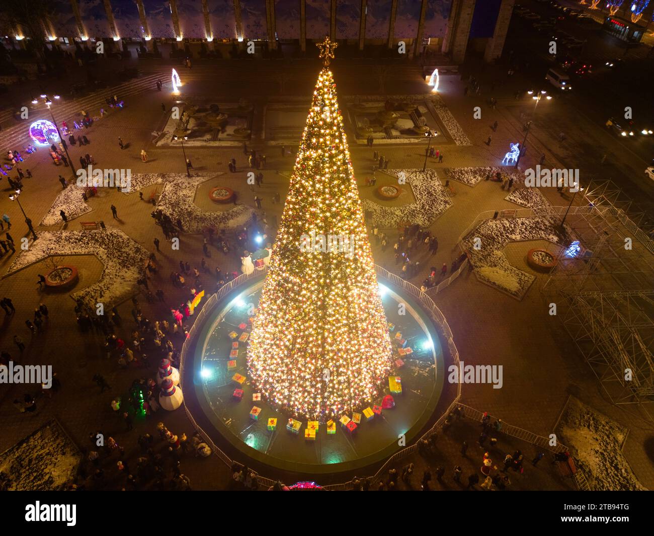 Aerial view of illuminated lights on a Christmas tree on a square with ...
