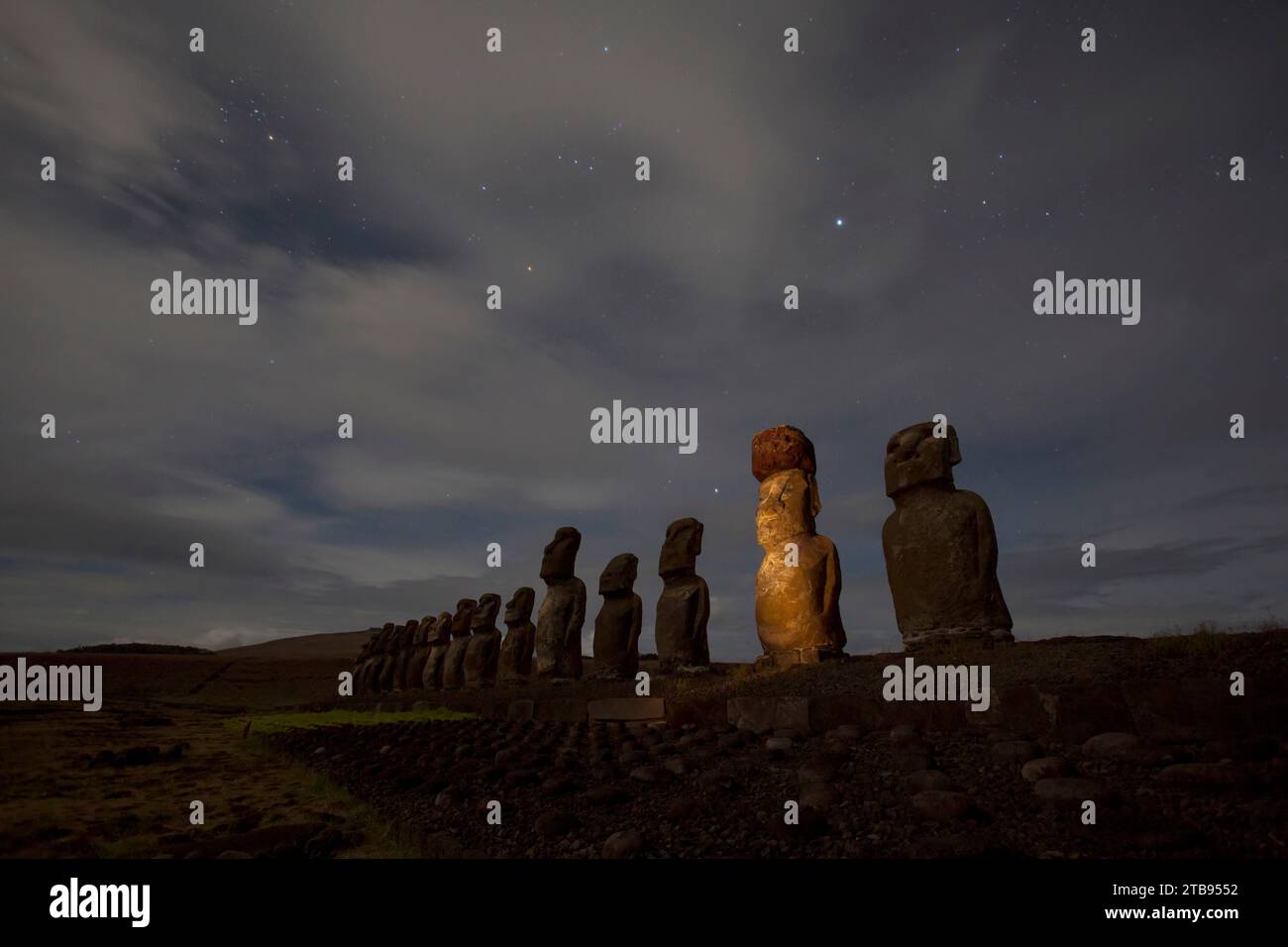 Moai stand as silhouettes beneath the night sky on Easter Island at ...