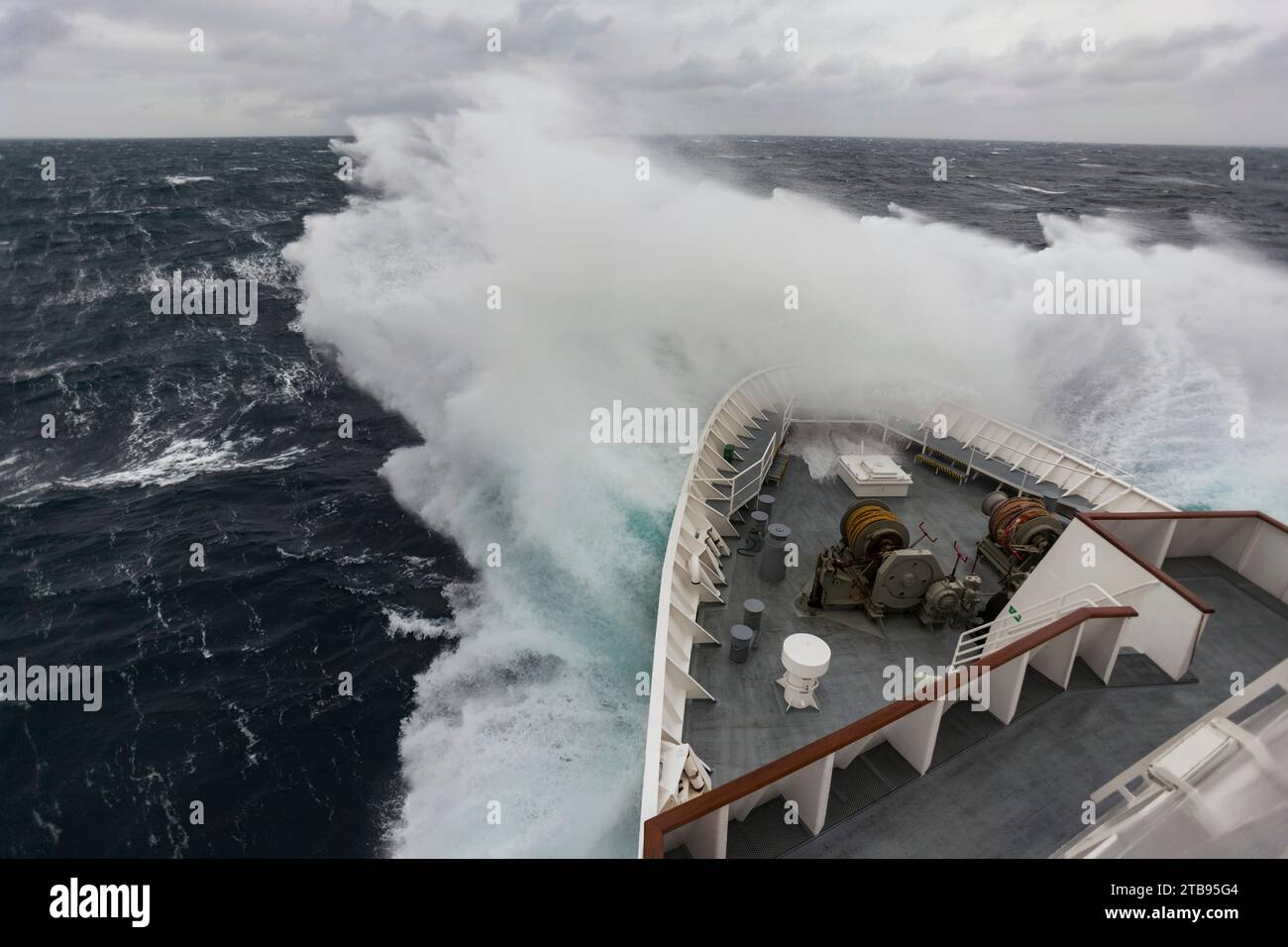 Waves crash against a cruise ship maneuvering through the Drake Passage ...