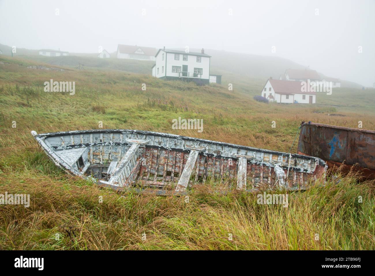 Dilapidated fishing boat sits high and dry in the grass; Battle Harbour ...