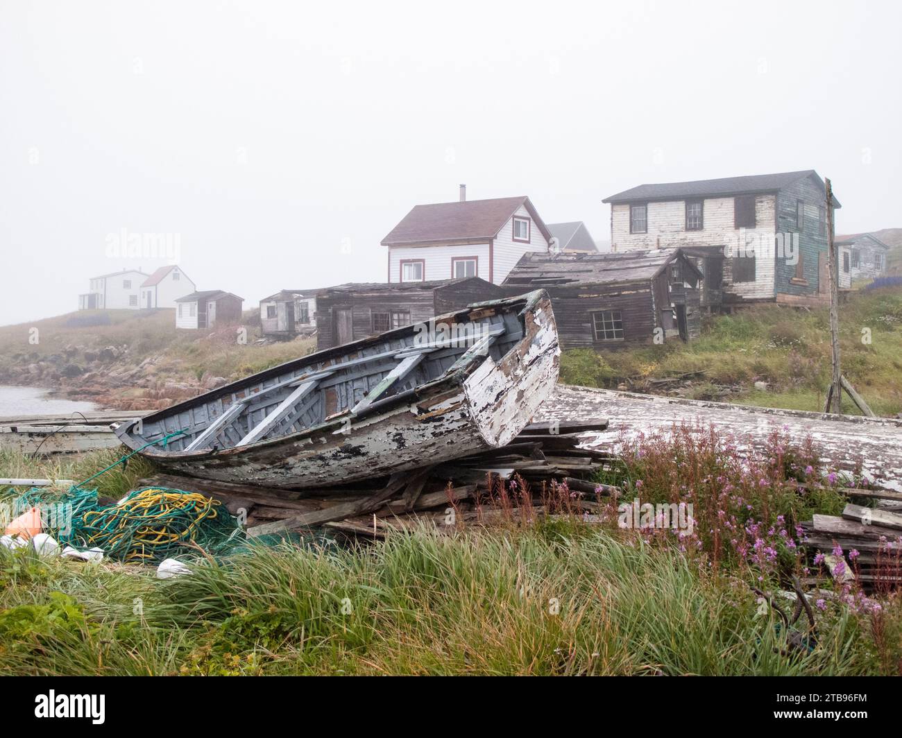 Dilapidated skiff by the shore sits atop a pile of building rubble ...