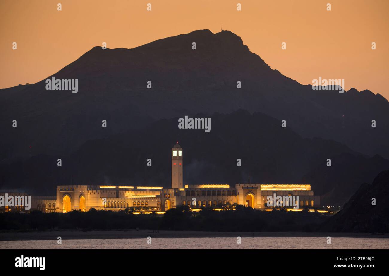 Illuminated building and tower along the coast of Oman, near Muscat ...