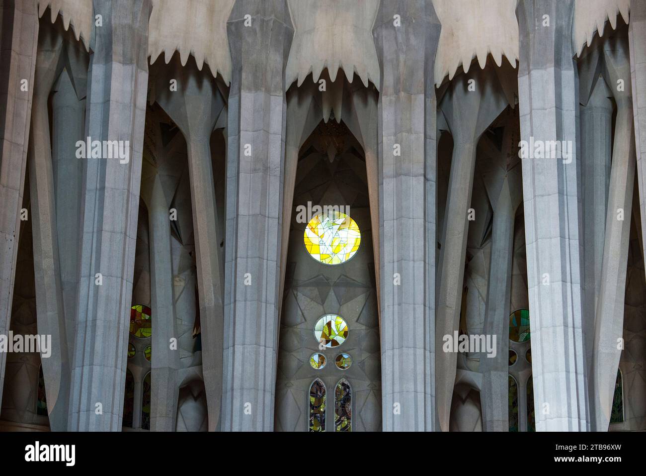 Interior view of columns and stain glass windows in Gaudi's Sagrada ...