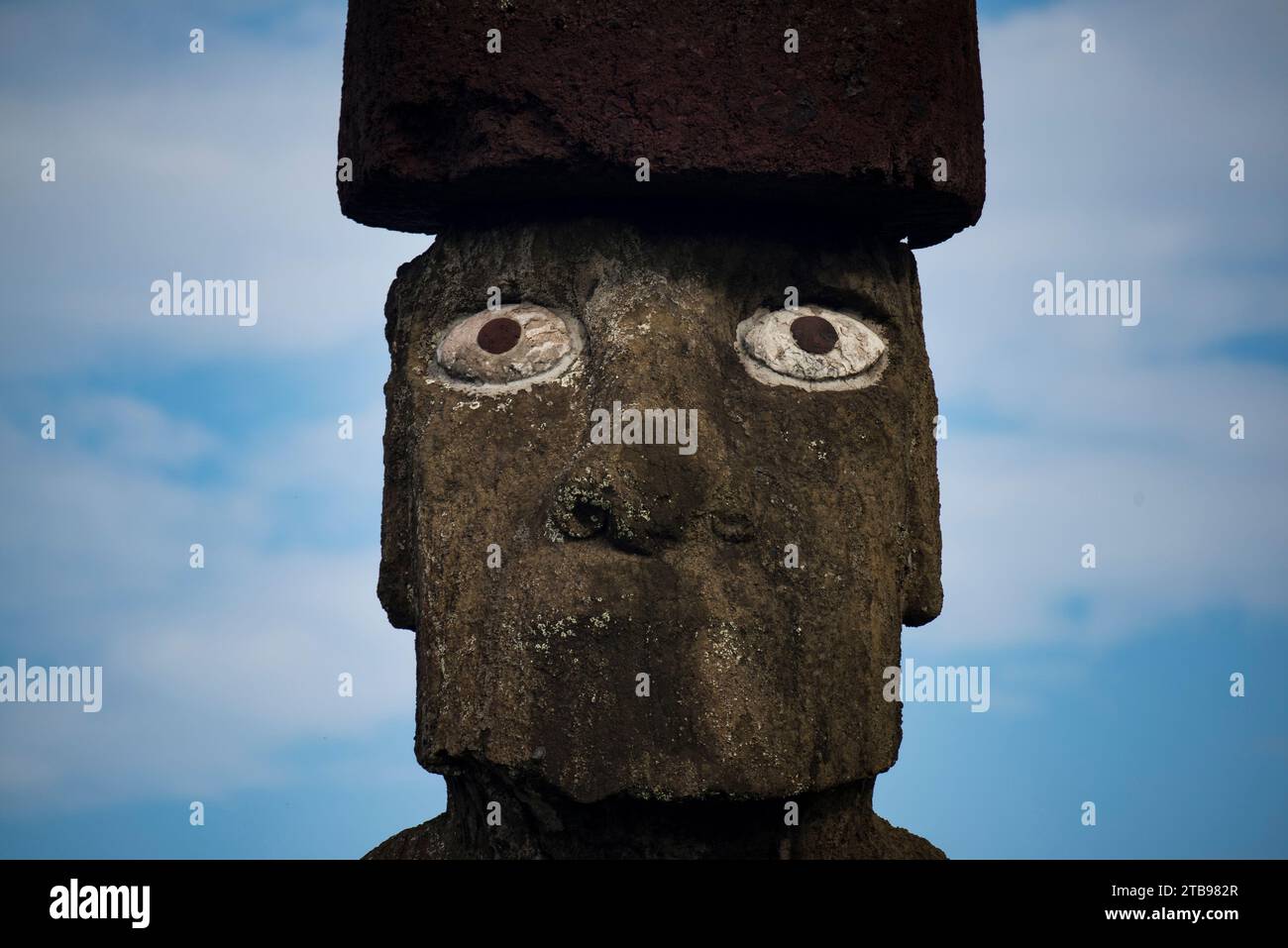 Close-up of a Moai against a blue sky with cloud at Rapa Nui National ...