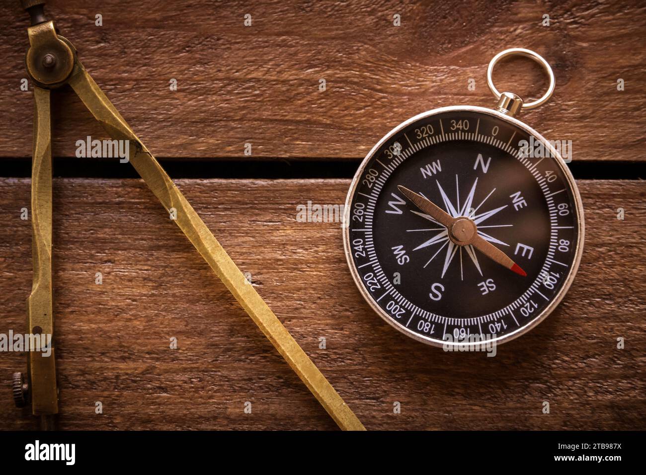 Vintage drawing and navigational Compass on a rustic wooden board Stock ...