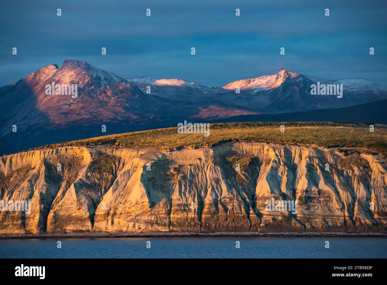 View of the cliffs along the coast of the Beagle Channel at sunset ...