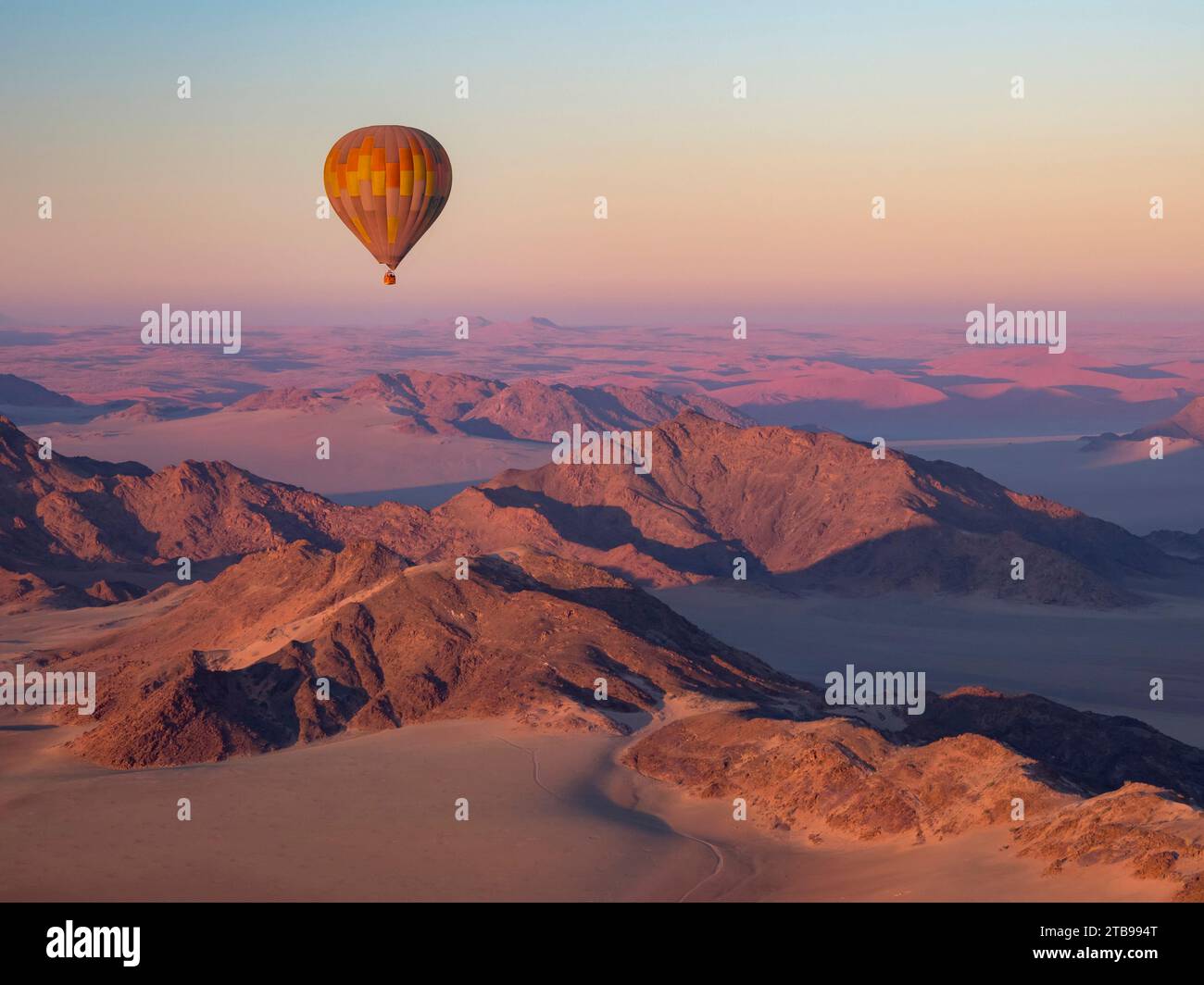 Early morning balloon ride over the sand and mountains in Namib ...