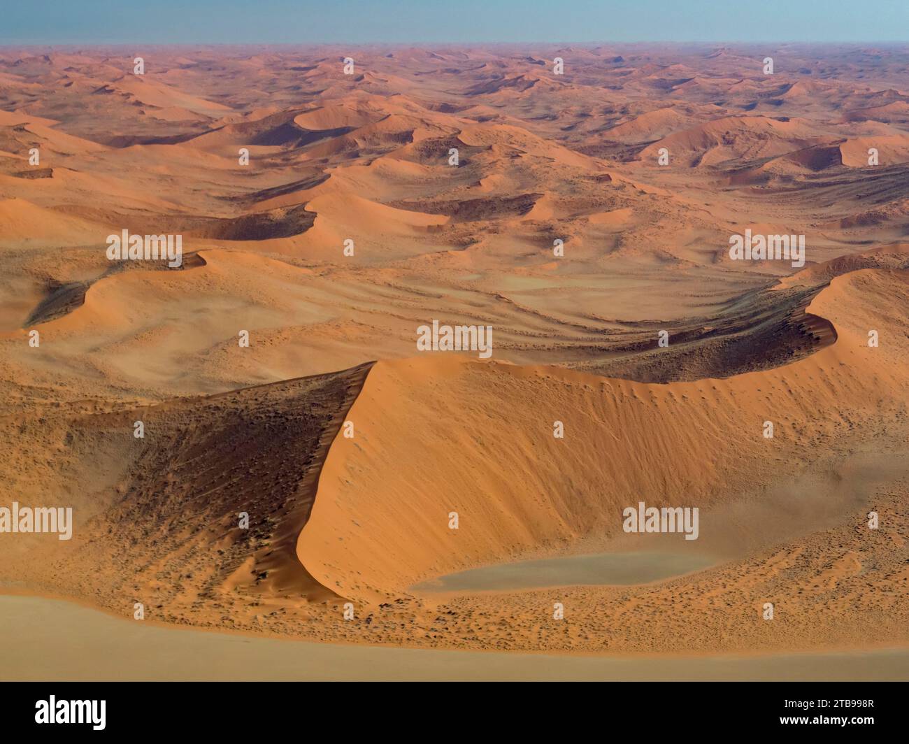 Aerial view of the miles upon miles of windblown sand dunes in Namib ...
